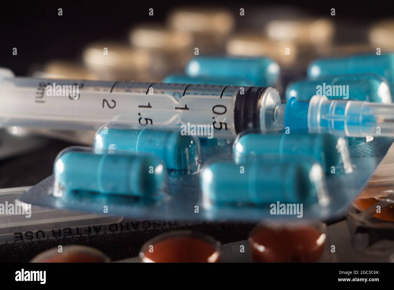 Closeup shot of pharmaceutical capsules, pills and syringes Stock Photo ...