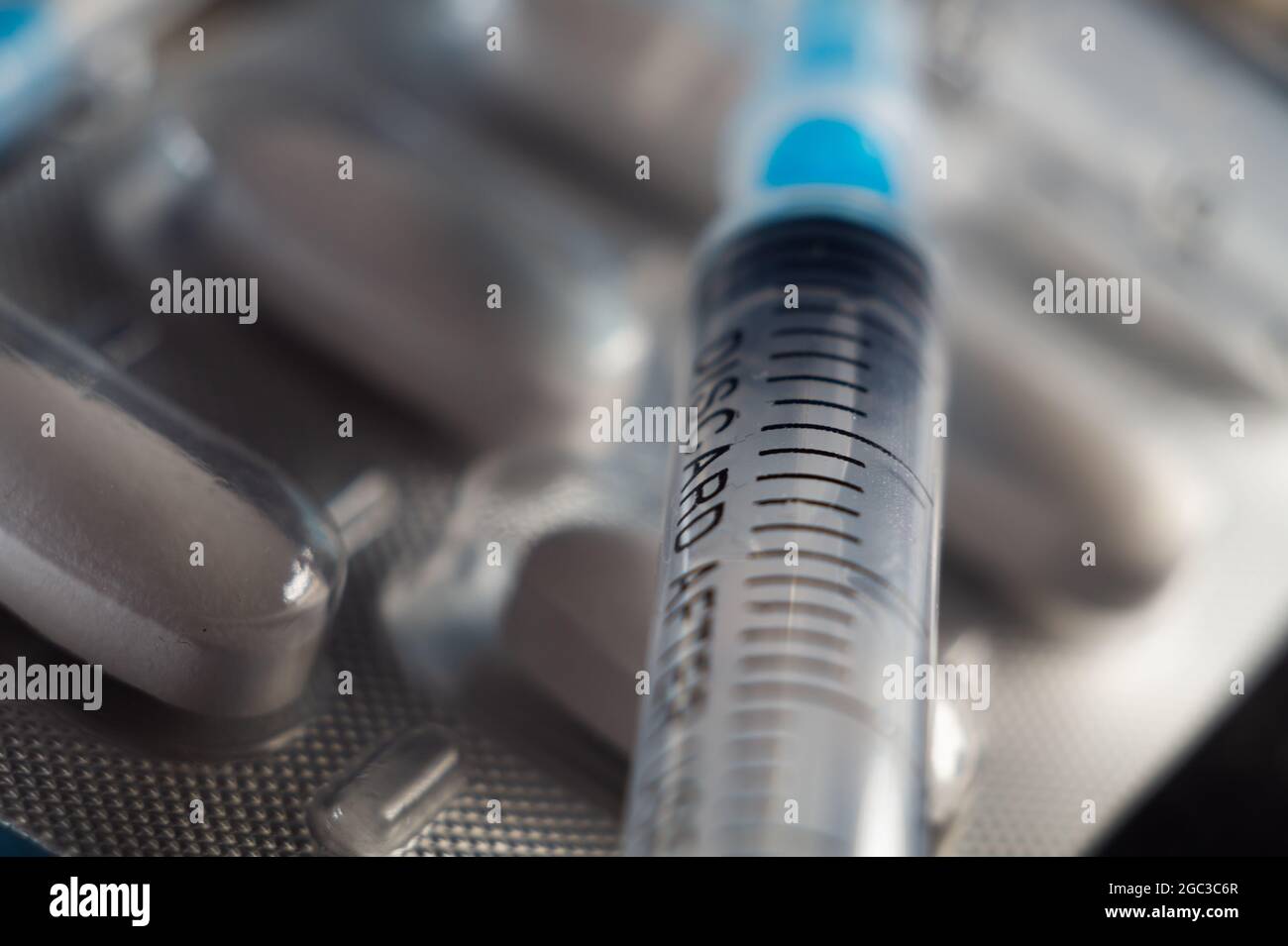 Closeup shot of pharmaceutical capsules, pills and syringes Stock Photo ...