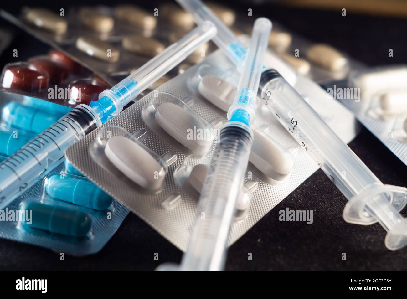 Closeup shot of pharmaceutical capsules, pills and syringes Stock Photo ...