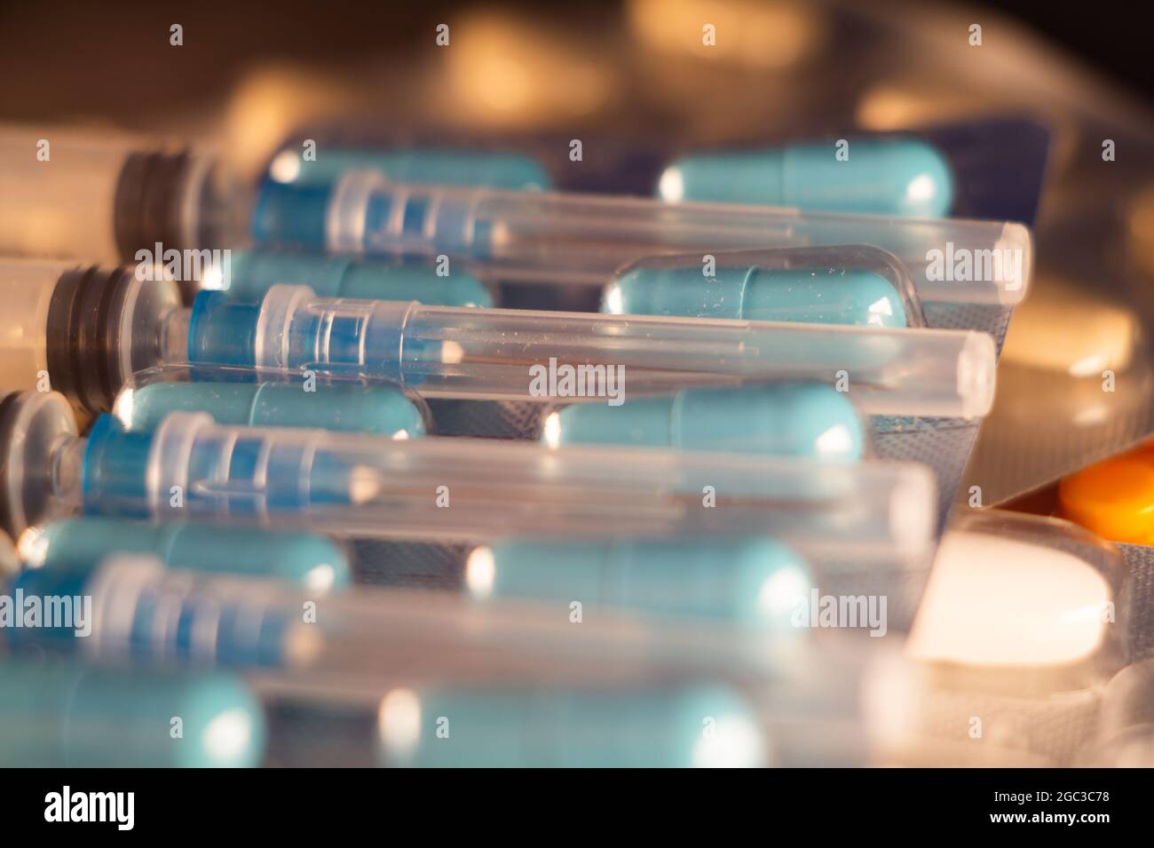 Closeup shot of pharmaceutical capsules, pills and syringes Stock Photo ...