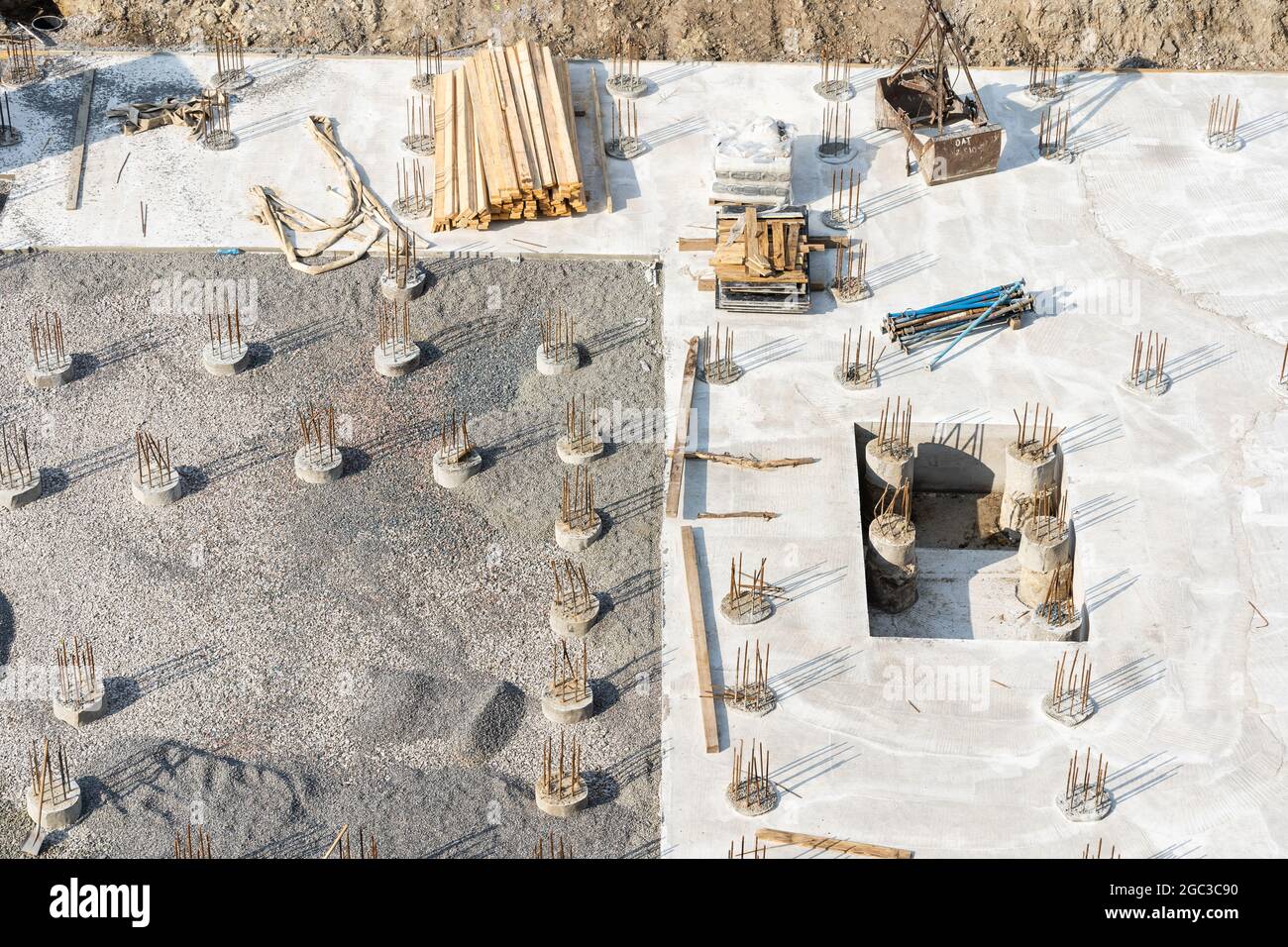 concreting work: construction site worker during concrete pouring into ...