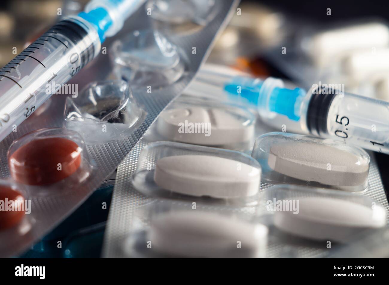 Closeup shot of pharmaceutical capsules, pills and syringes Stock Photo ...