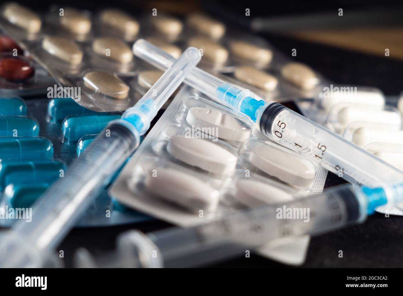 Closeup shot of pharmaceutical capsules, pills and syringes Stock Photo ...