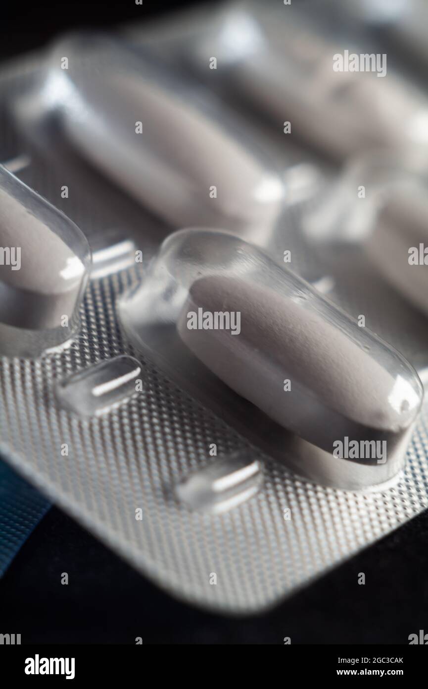 Vertical shot of white pharmaceutical capsules Stock Photo - Alamy