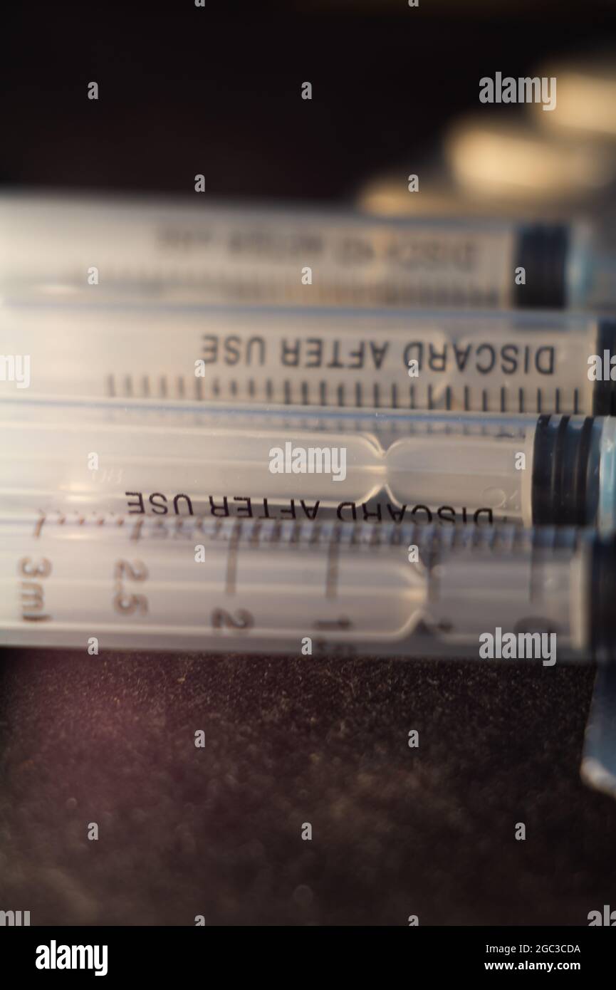 Vertical shot of pharmaceutical capsules, pills and syringes Stock ...