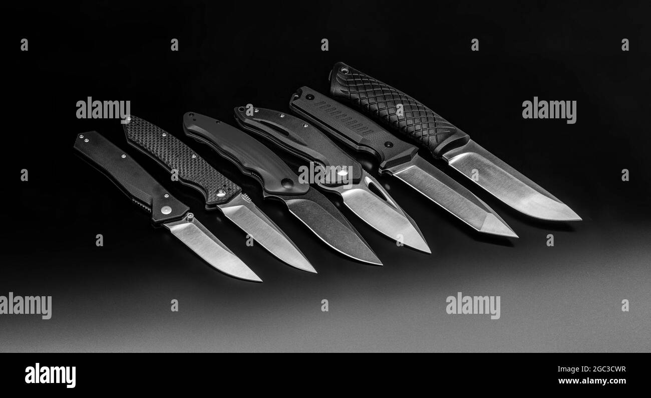 folding knives on a black background. pen knives on a dark background ...
