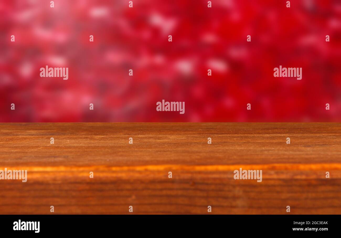Wooden table on bright red background Stock Photo - Alamy