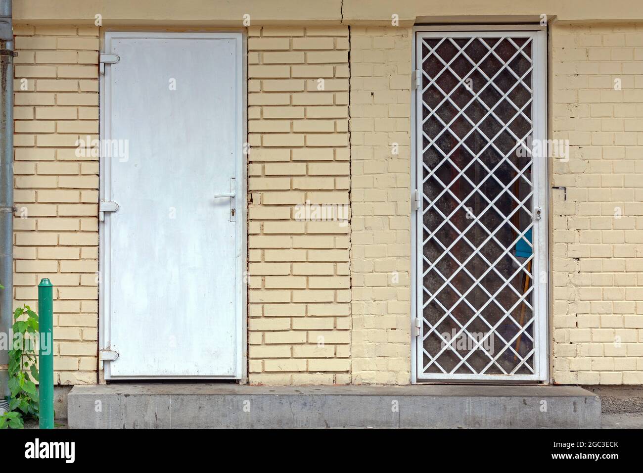 Two Closed Doors at Yellow Bricks Building Stock Photo - Alamy