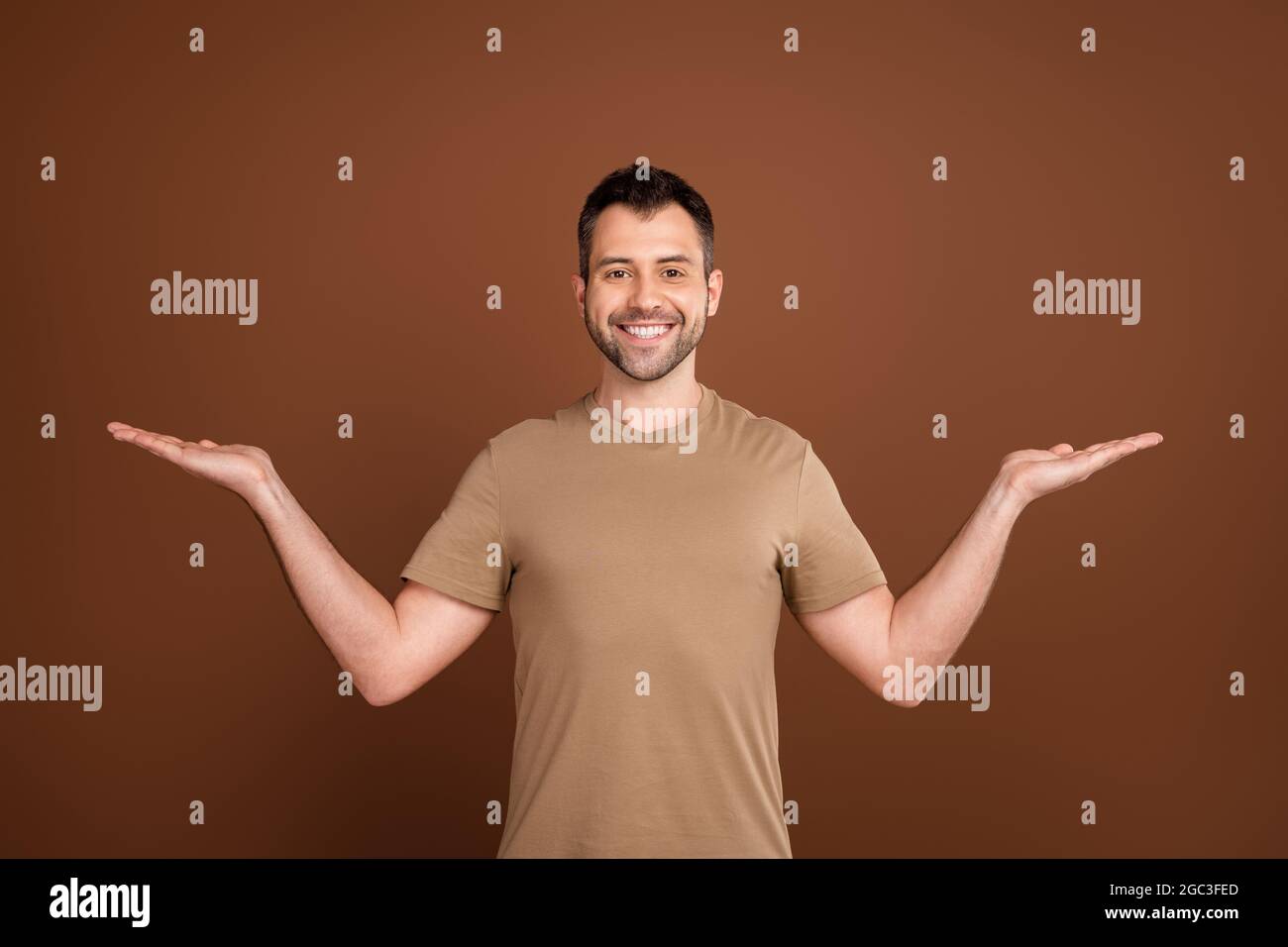 Photo of pretty adorable young guy dressed beige clothes smiling ...