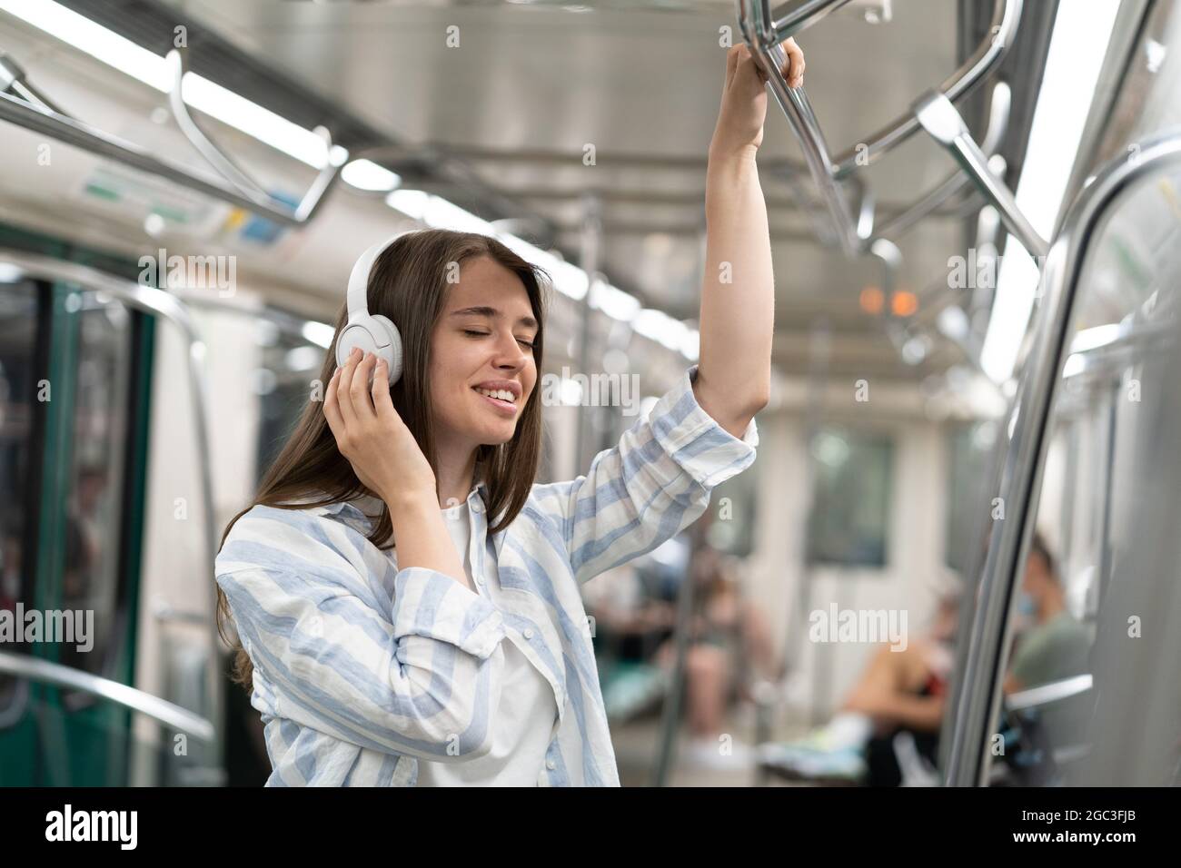 Carefree millennial cute girl passenger listening to music with ...