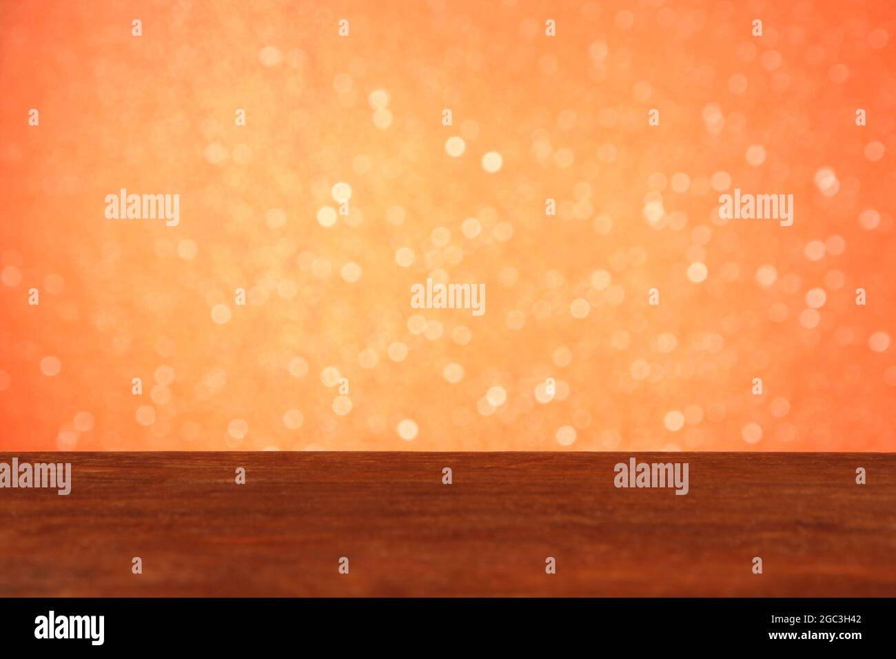 Wooden table on orange background Stock Photo - Alamy
