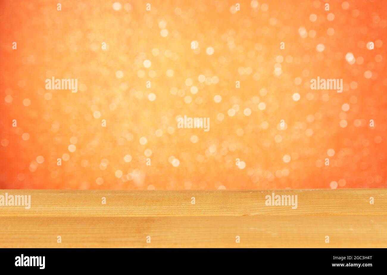 Wooden table on orange background Stock Photo - Alamy