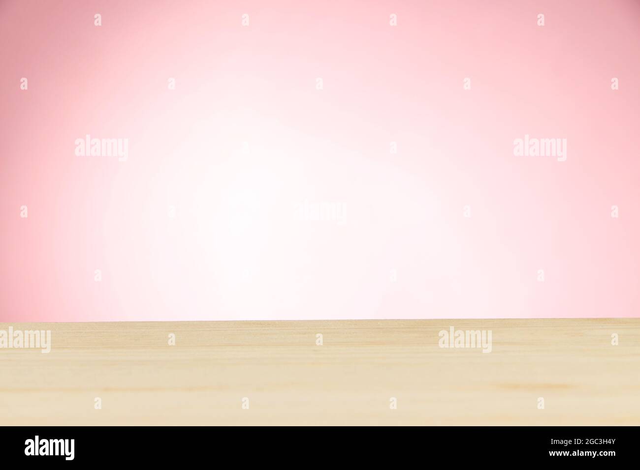 Wooden table on light pink background Stock Photo - Alamy