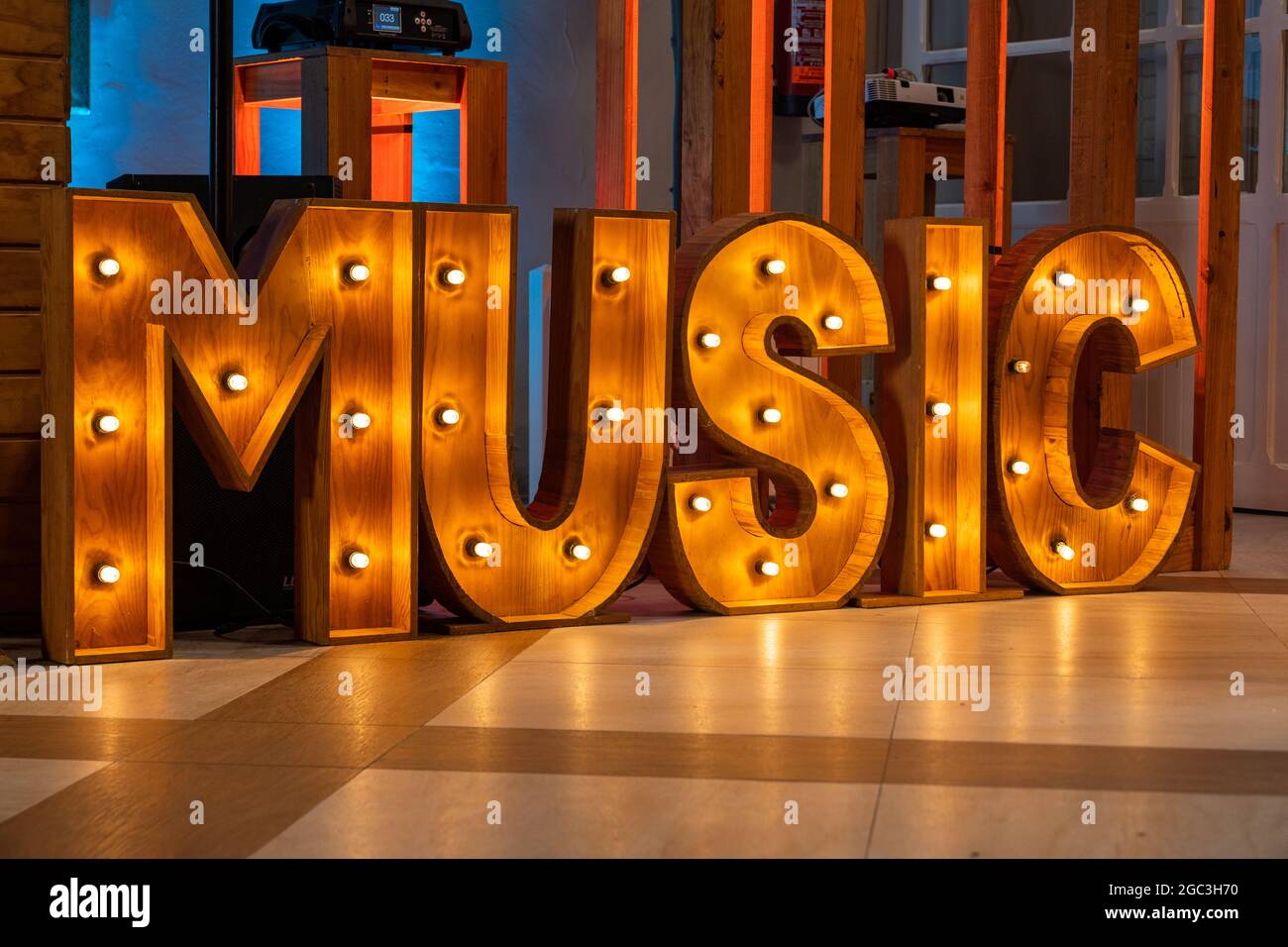 Lighted volumetric letters on the floor inside the venue making up the ...