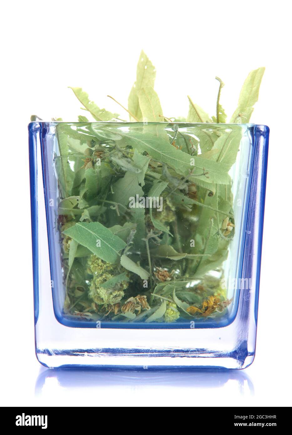 Dried herb in glass container isolated on white Stock Photo - Alamy