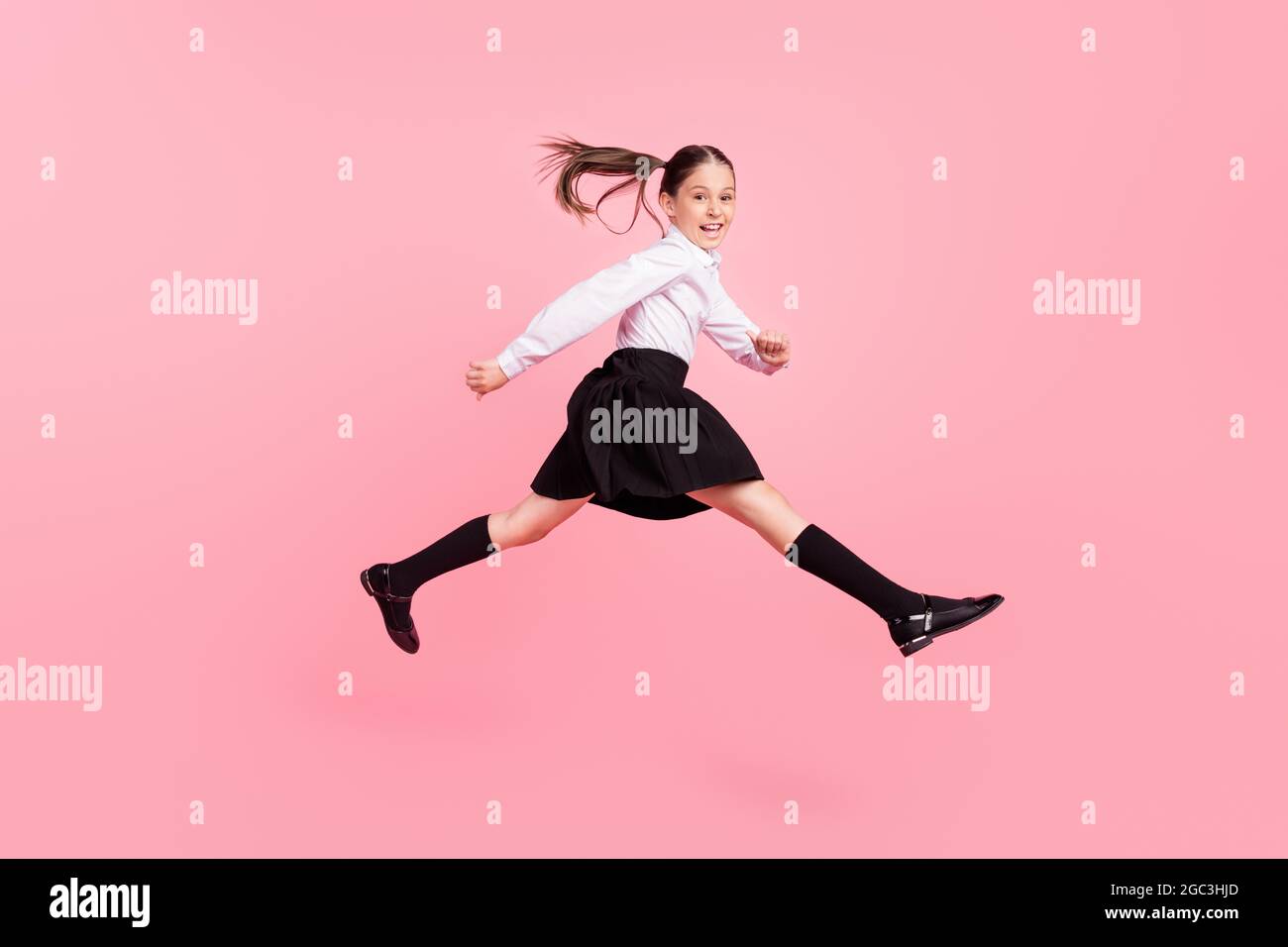 Full body photo of young happy positive cheerful girl jump up run empty ...