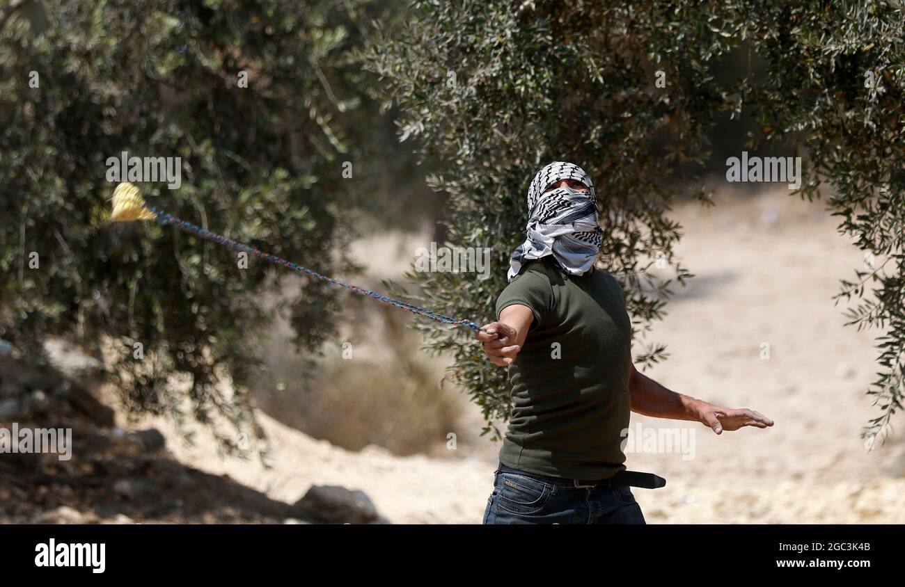 Palestinian man uses slingshot palestinian hi-res stock photography and ...