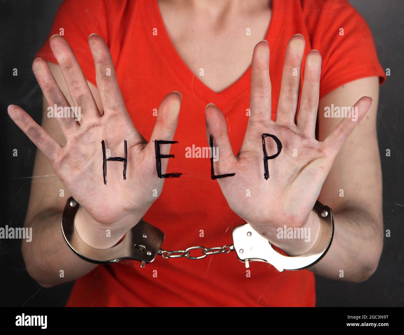 Prisoner in handcuffs behind glass in soundproof room Stock Photo - Alamy