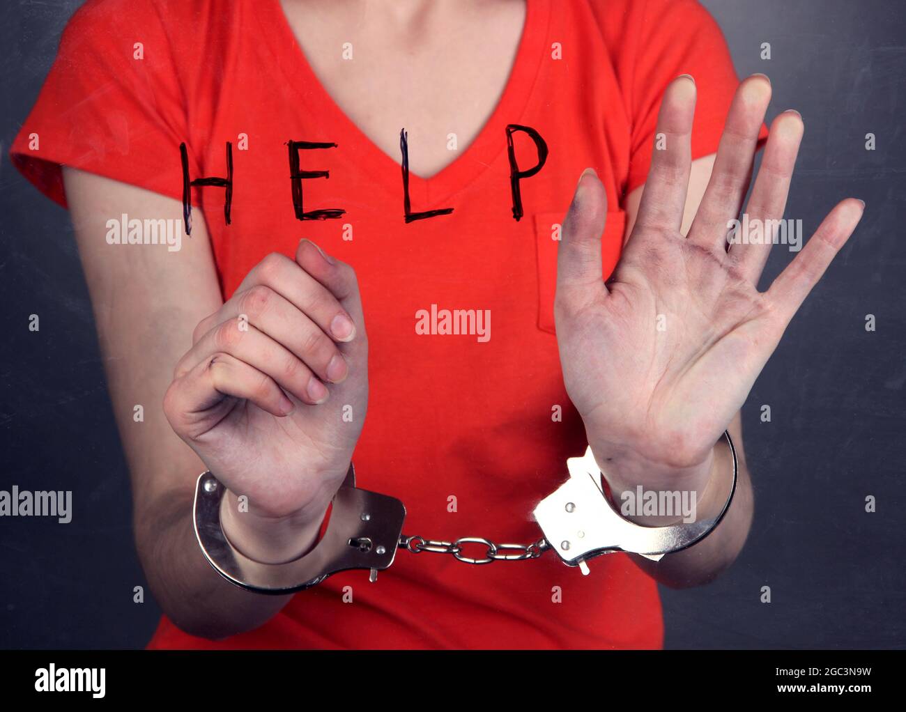 Prisoner in handcuffs behind glass in soundproof room Stock Photo - Alamy