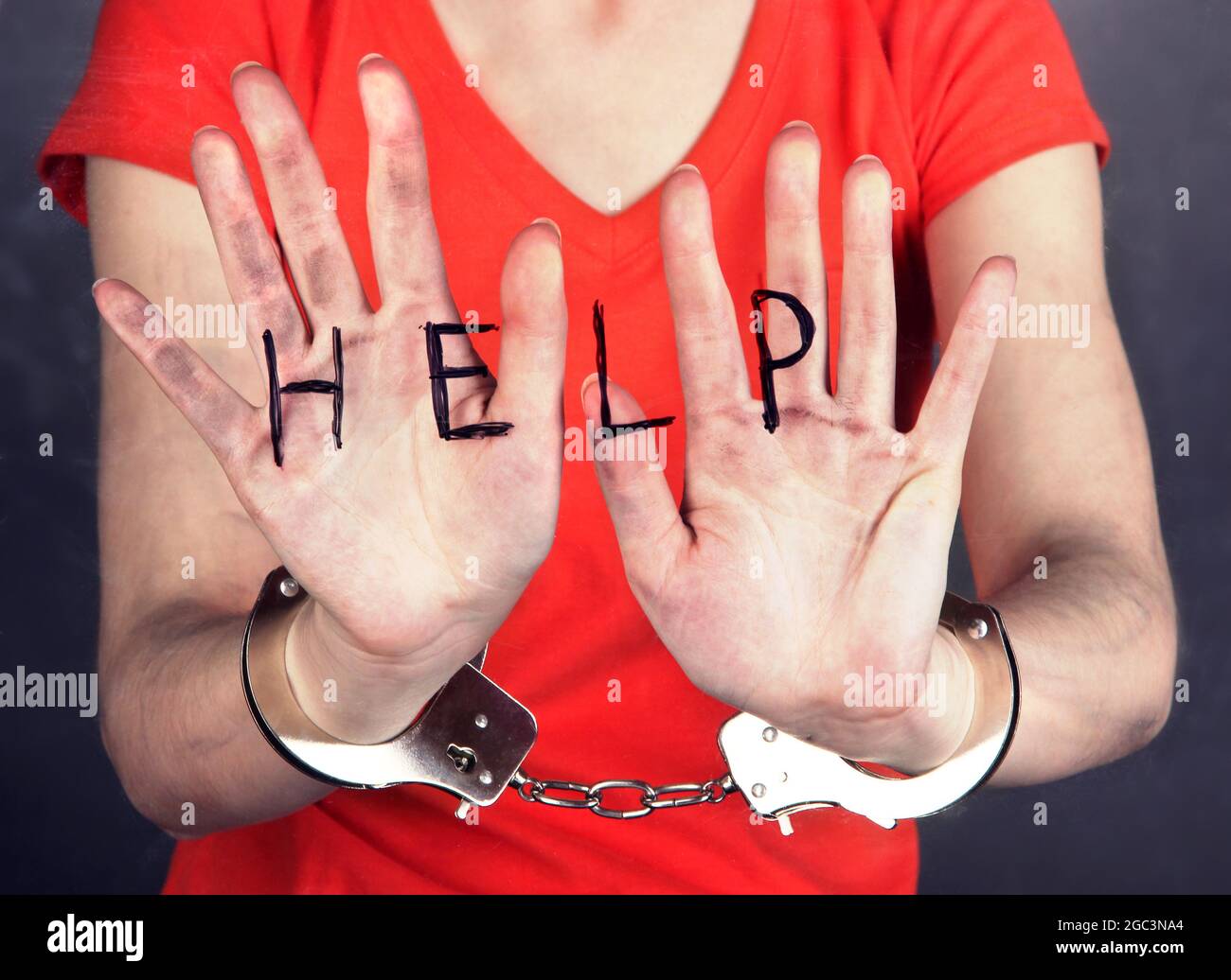 Prisoner in handcuffs behind glass in soundproof room Stock Photo - Alamy