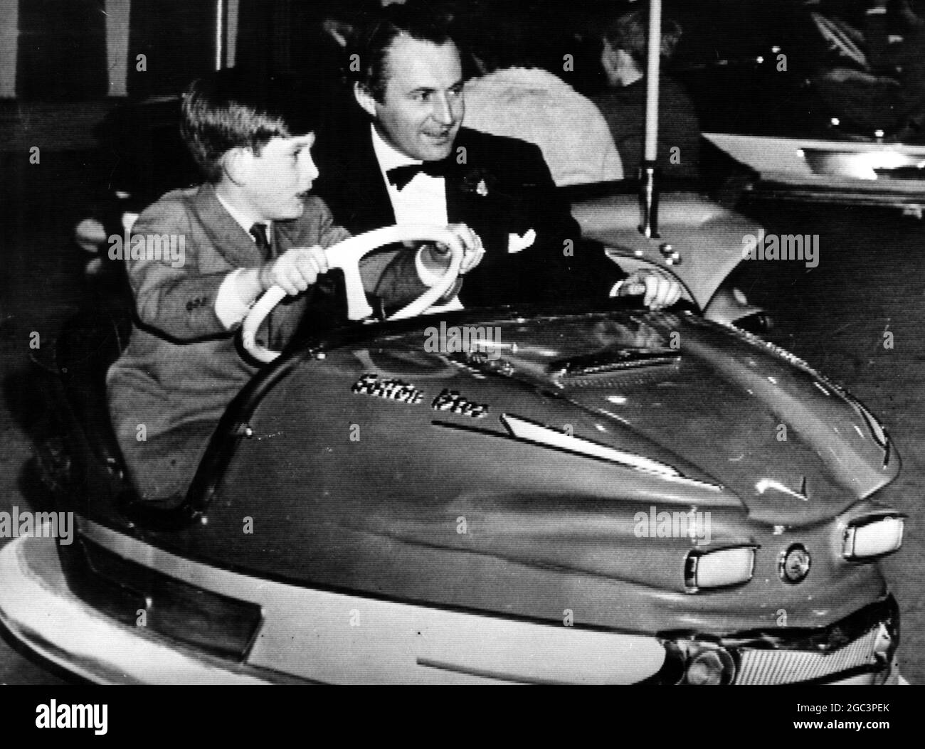 Prince Charles rides in a bumper car with David Monk. 18 December 1959 ...