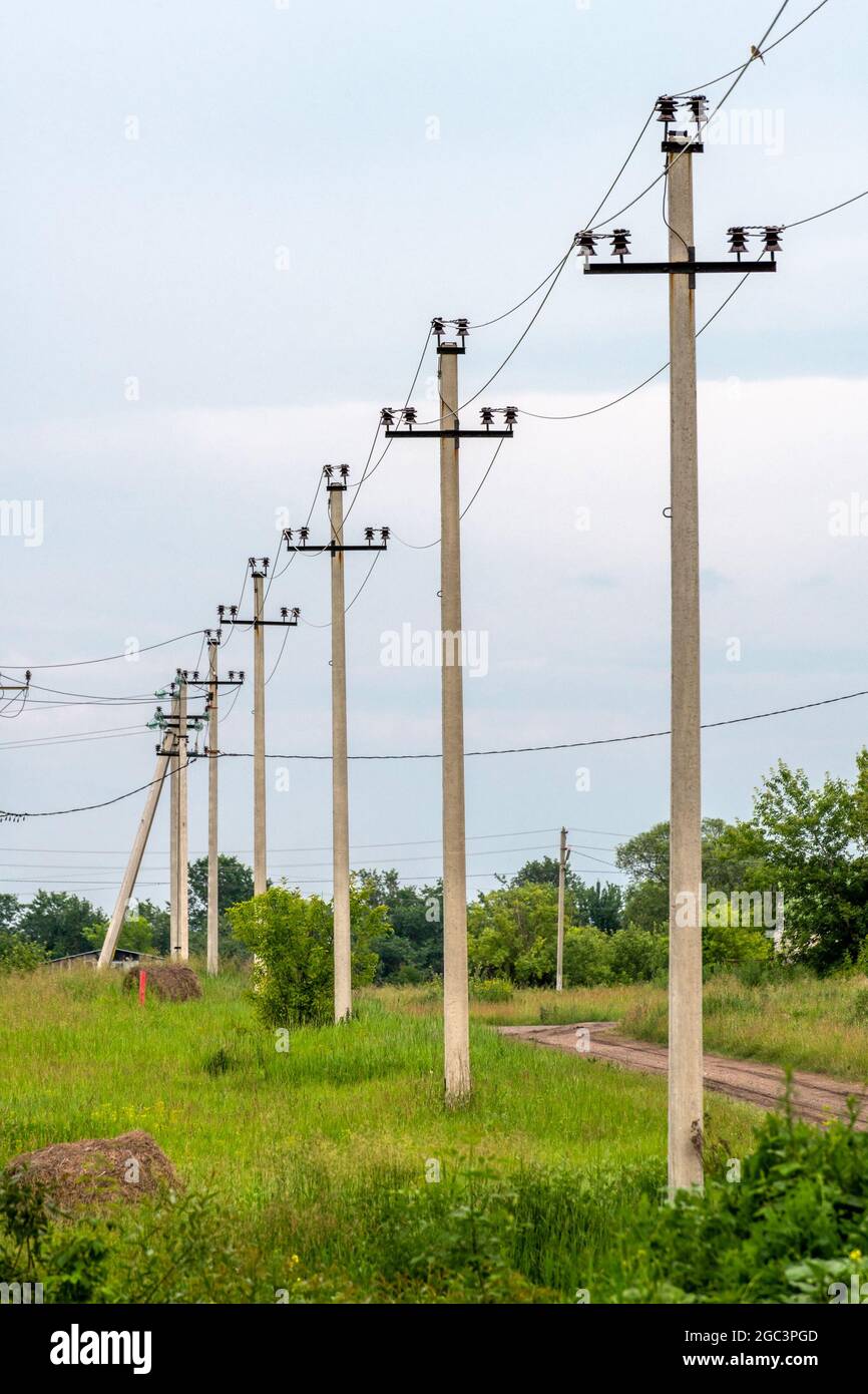 Concrete power lines in the village Stock Photo - Alamy