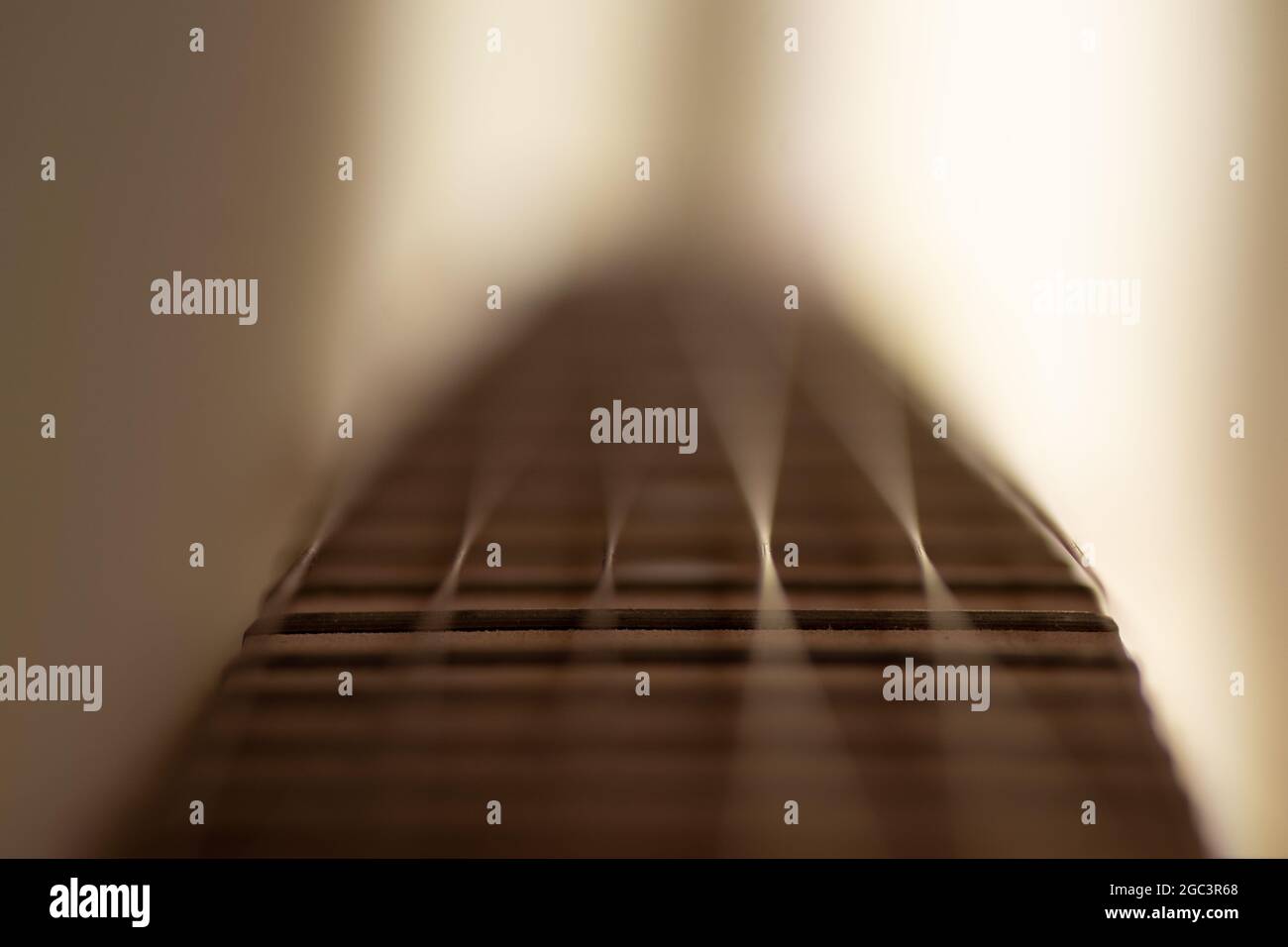Closeup detail of steel guitar strings and frets for making music ...