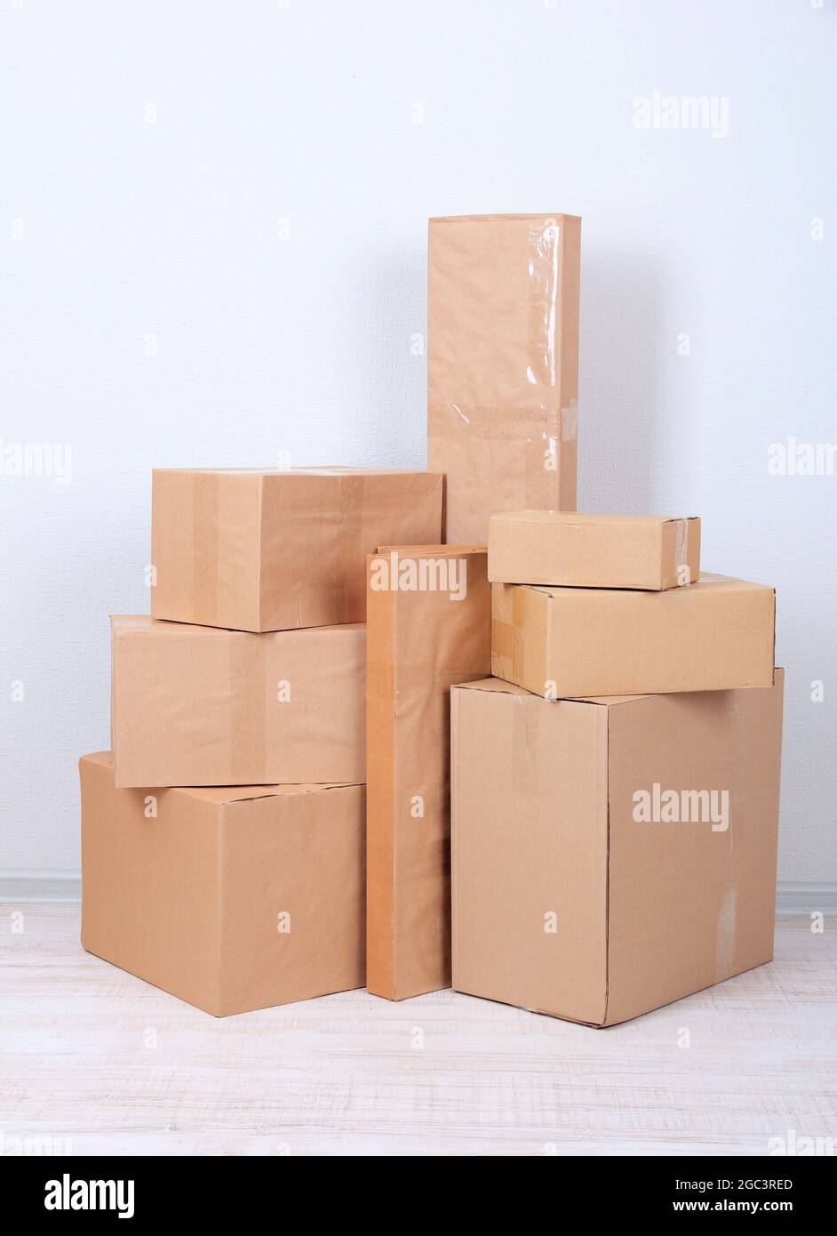 Different cardboard boxes in room Stock Photo - Alamy