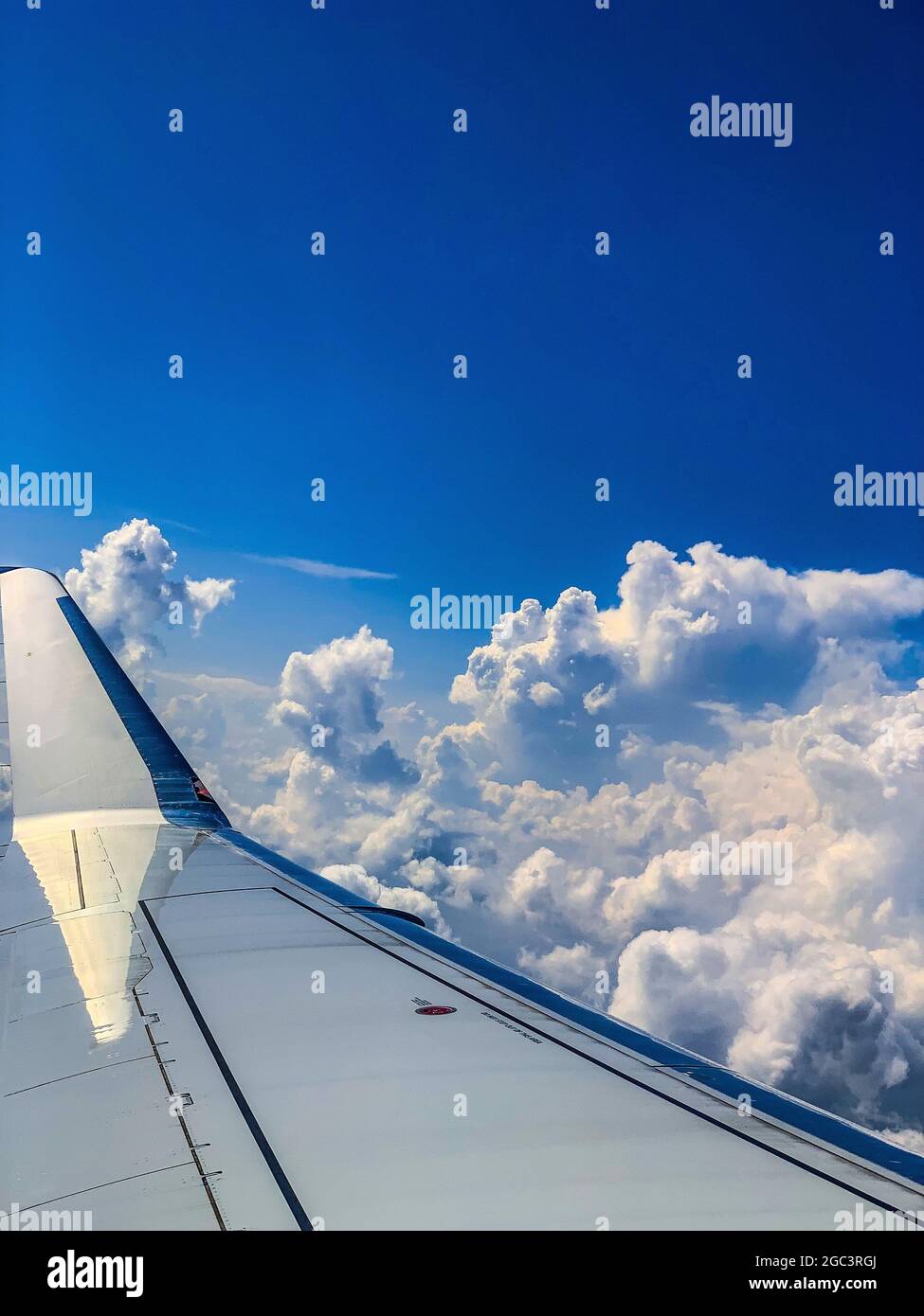 Breathtaking cloudy sky and wing view from the window of the internal ...