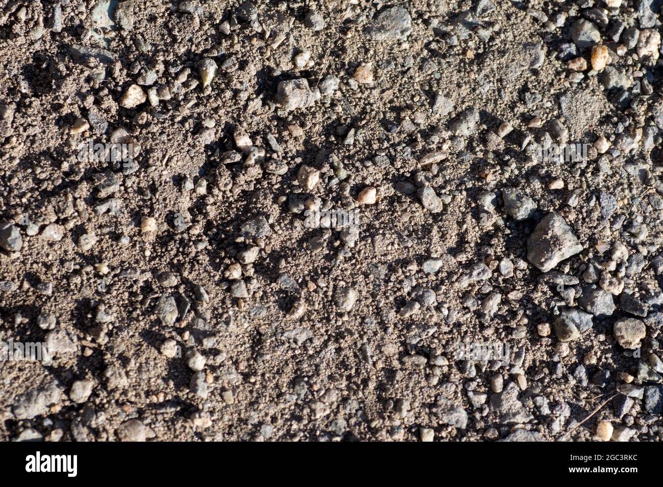 Coarse gravel, pebbles and sand are black, multicolor. Background ...