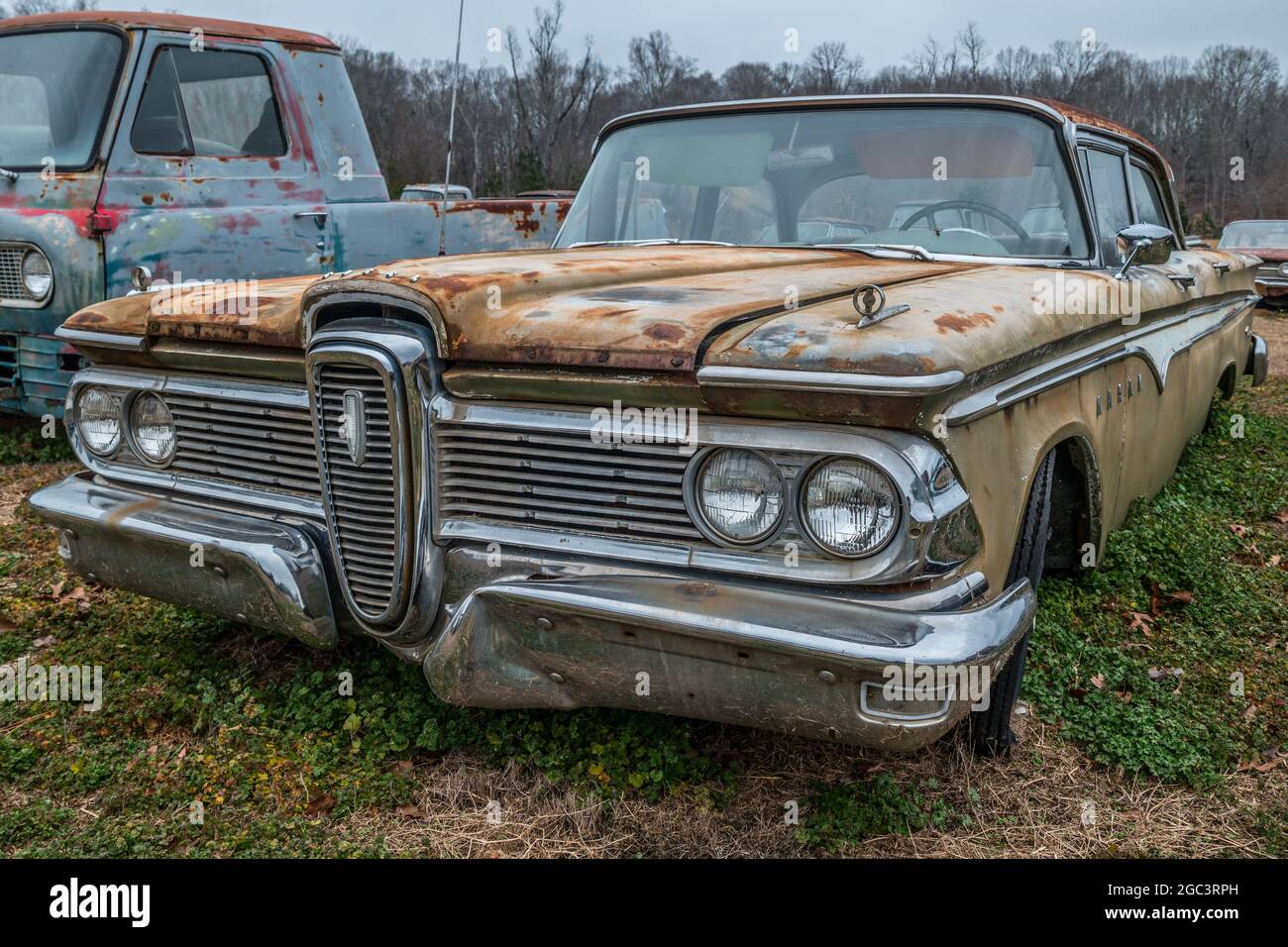 A fully intact 1950's Edsel discarded in a field with other cars ...