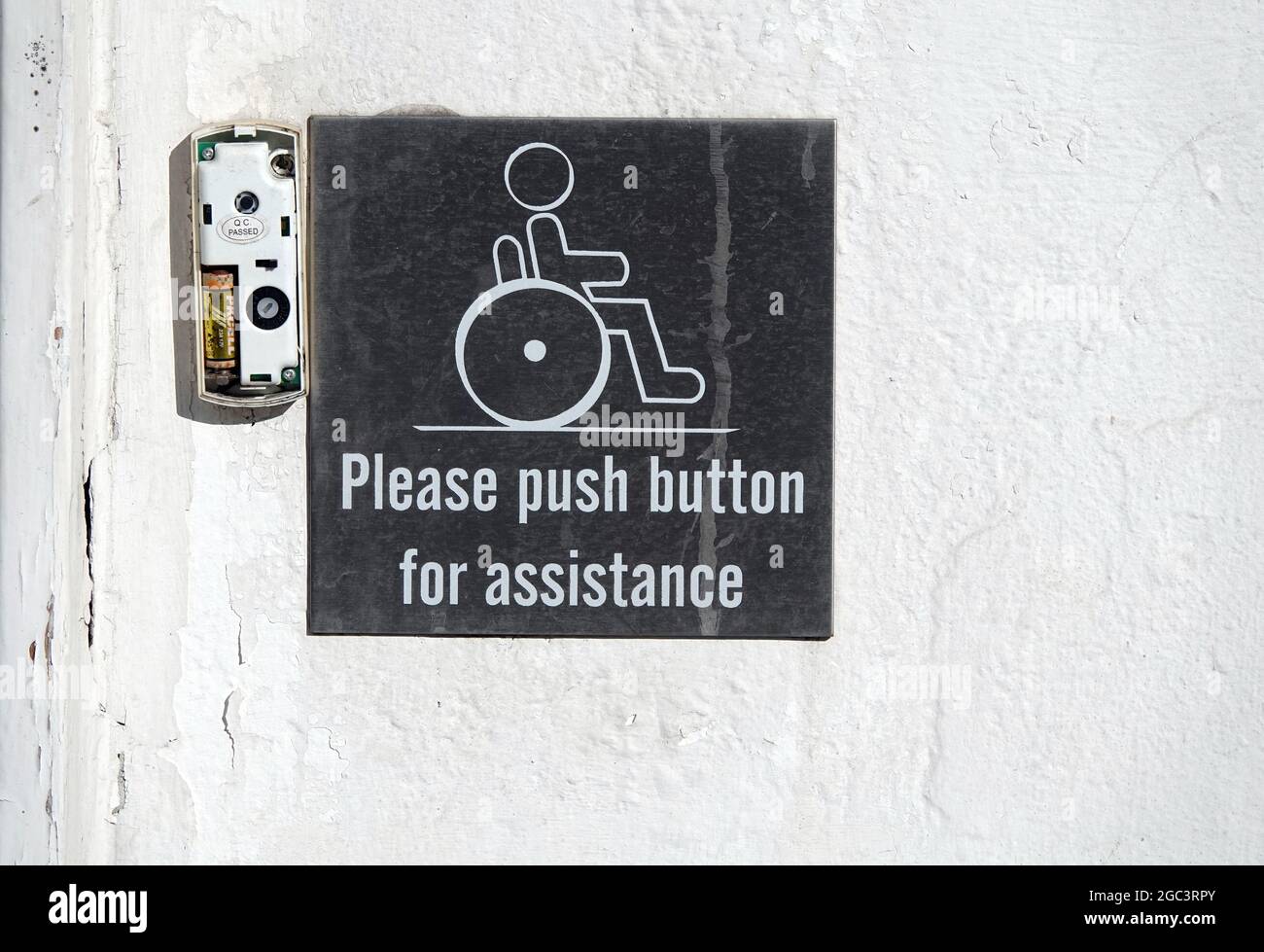 Closeup shot of a disabled handicap sign with Please push button for ...