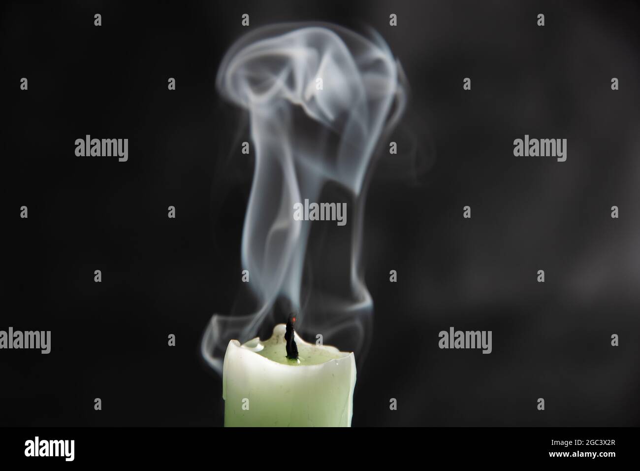 extinct light green candle with spectacular abstract smoke on a black ...