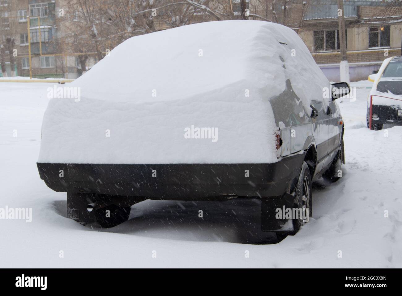 Parked car covered with white snow, snow storm, car after a heavy ...