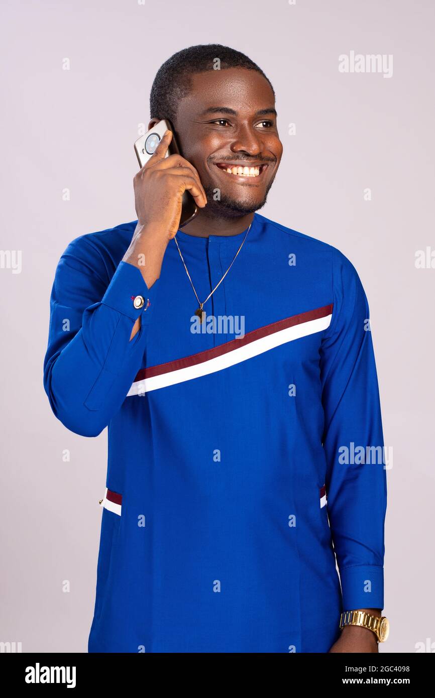 happy young black man smiling while making a phone call Stock Photo - Alamy