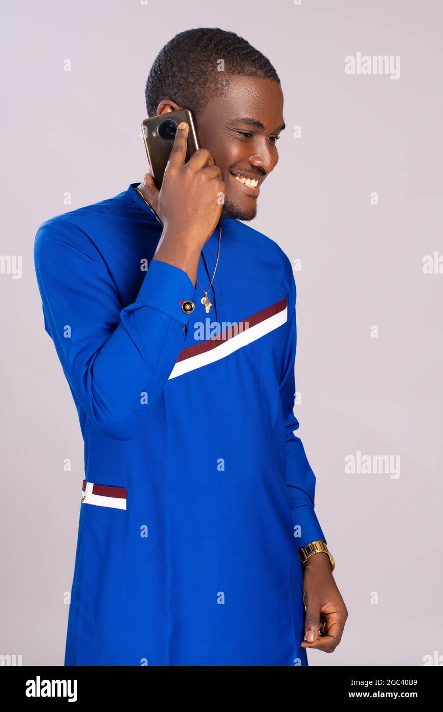 young african man smiling while making a phone call Stock Photo - Alamy