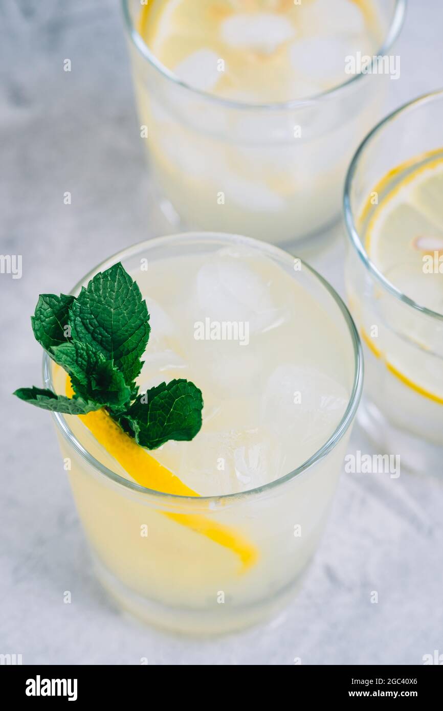 Ice lemonade in glass with lemon pieces, fresh mint and ice cubes Stock ...