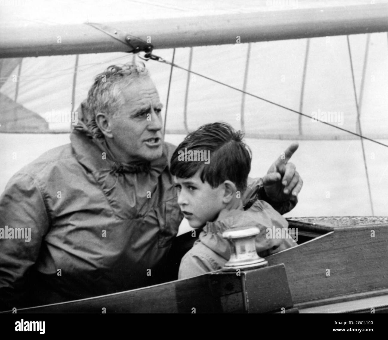 Uffa Fox and Prince Charles sailing - yacht racing at Cowes. In the ...