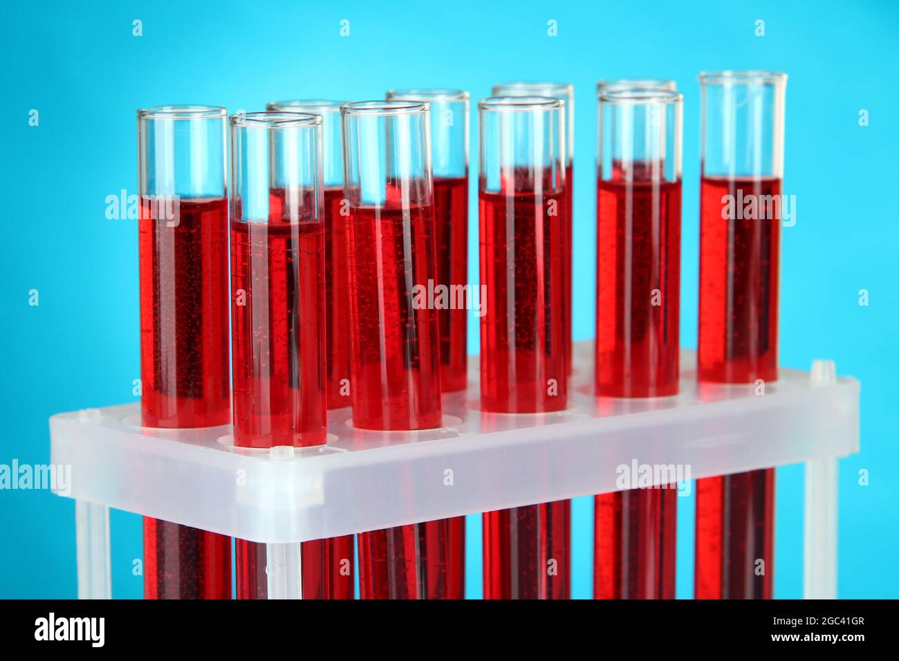 Test tubes with blood in laboratory on blue background Stock Photo - Alamy