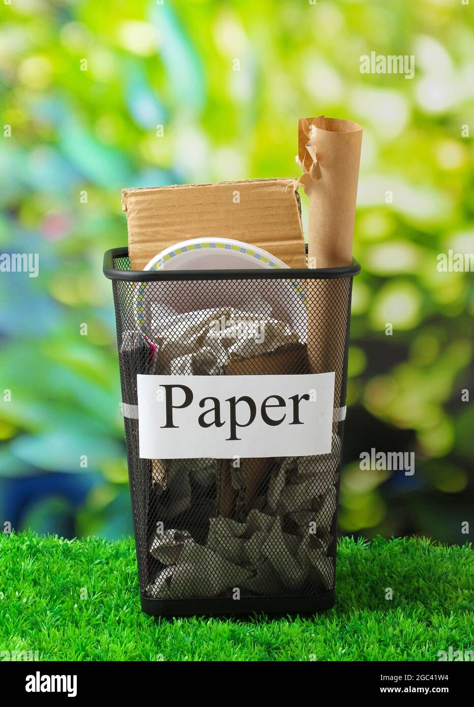 Assorted trash in bucket on nature background Stock Photo - Alamy