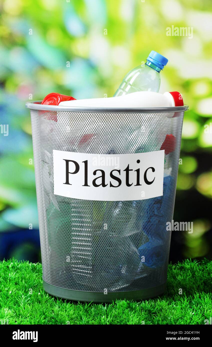 Assorted trash in bucket on nature background Stock Photo - Alamy