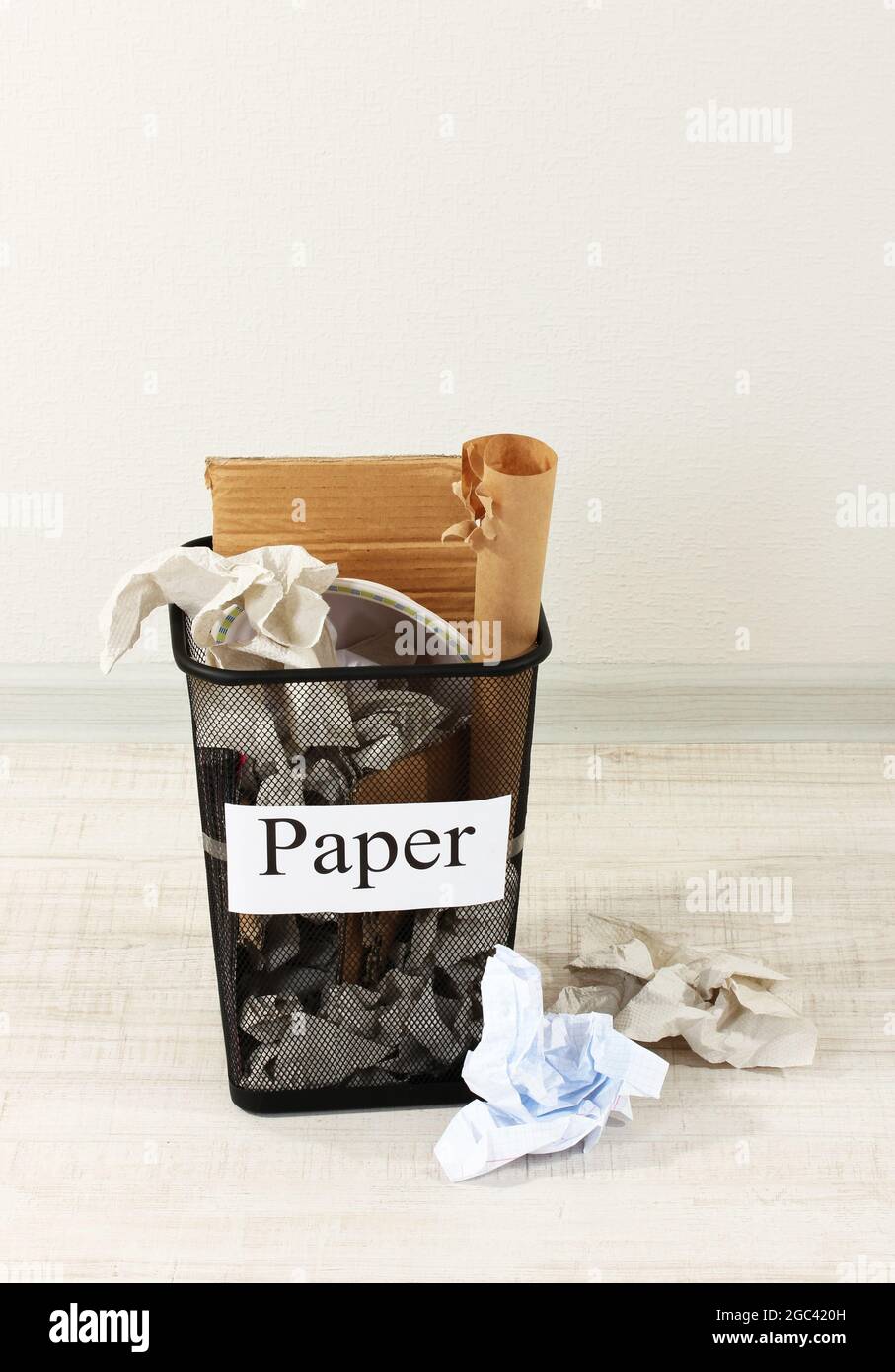 Assorted trash in bucket on room background Stock Photo - Alamy