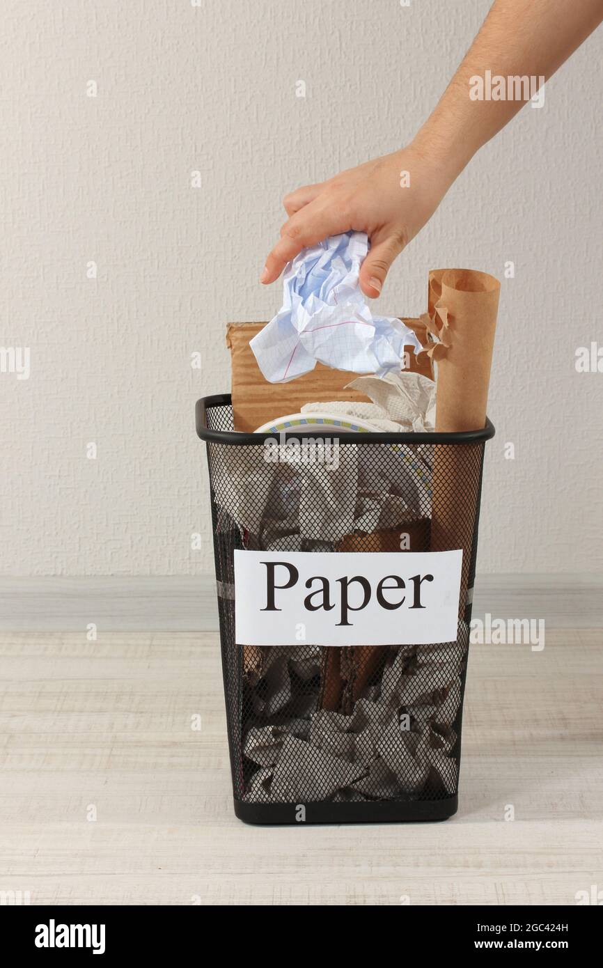 Assorted trash in bucket on room background Stock Photo - Alamy