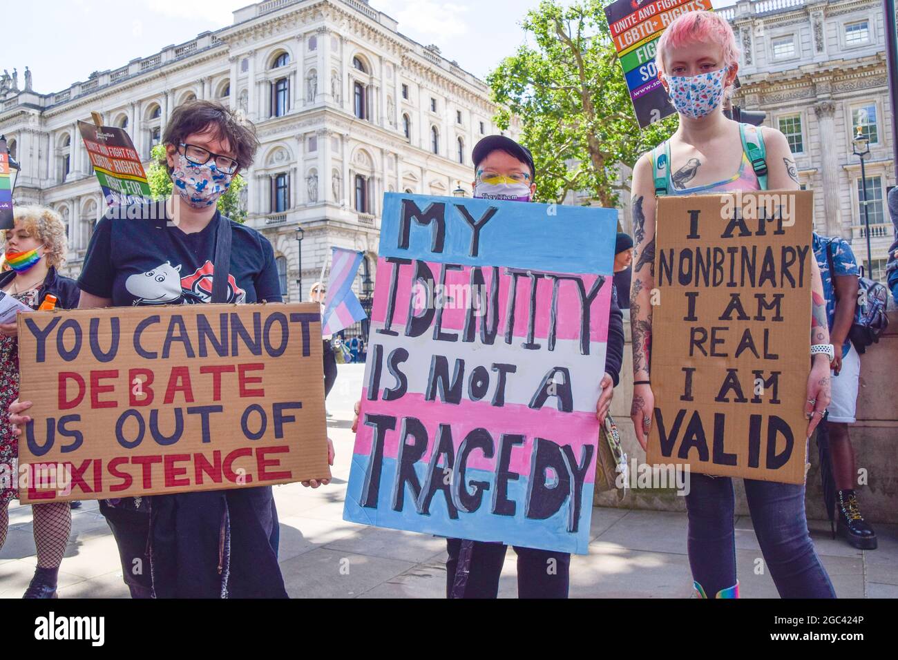 Protesters hold pro-trans rights placards during the trans rights ...