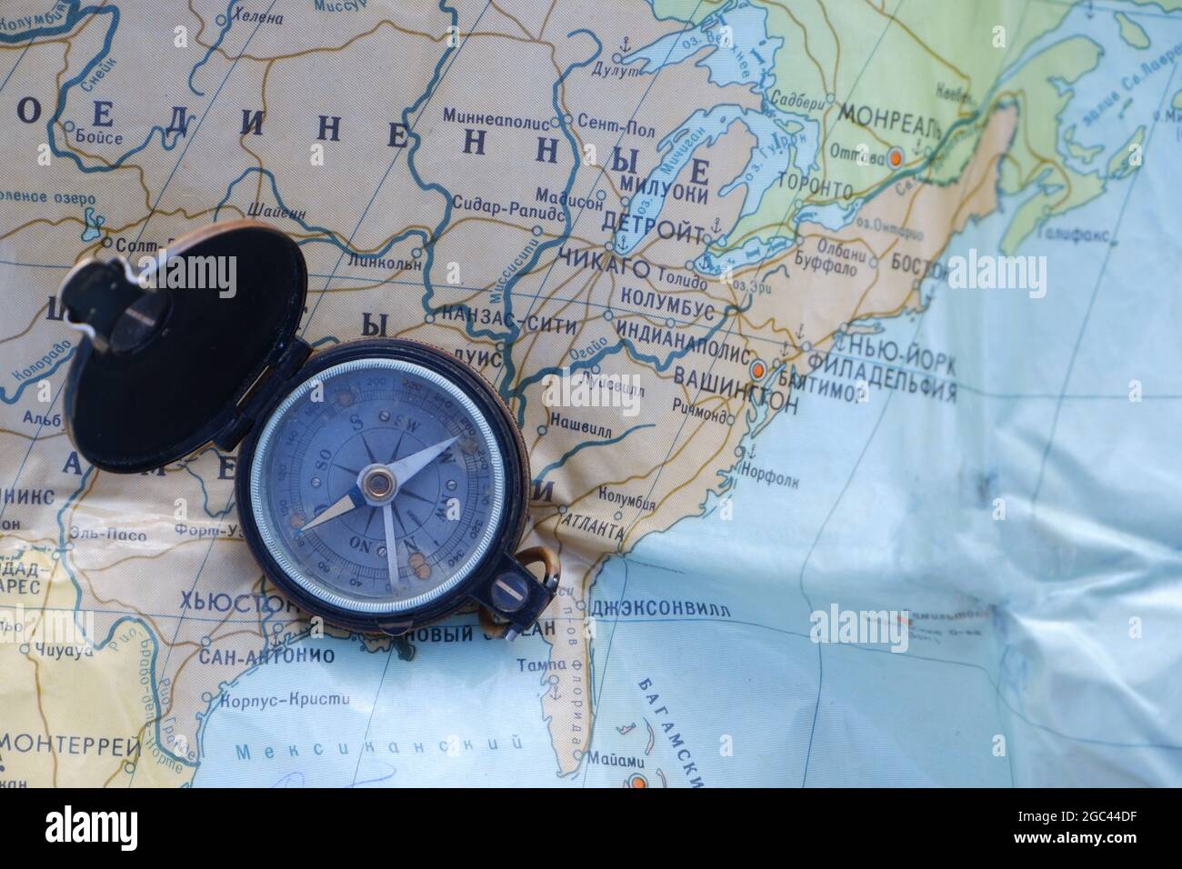 Old compass on the Russian-language map of the world. Concept. World ...