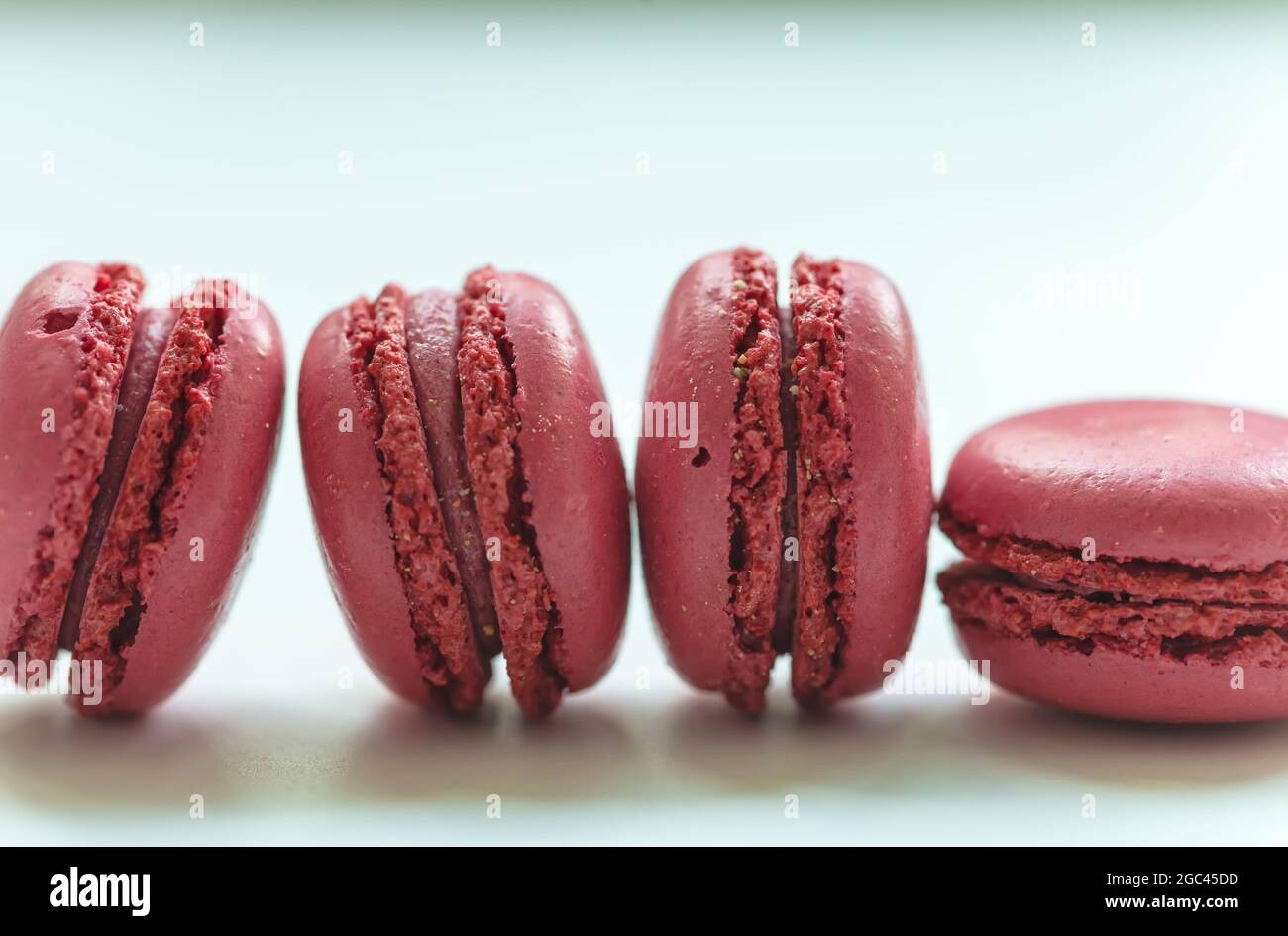 Raspberry flavored macaroons in white background Stock Photo - Alamy
