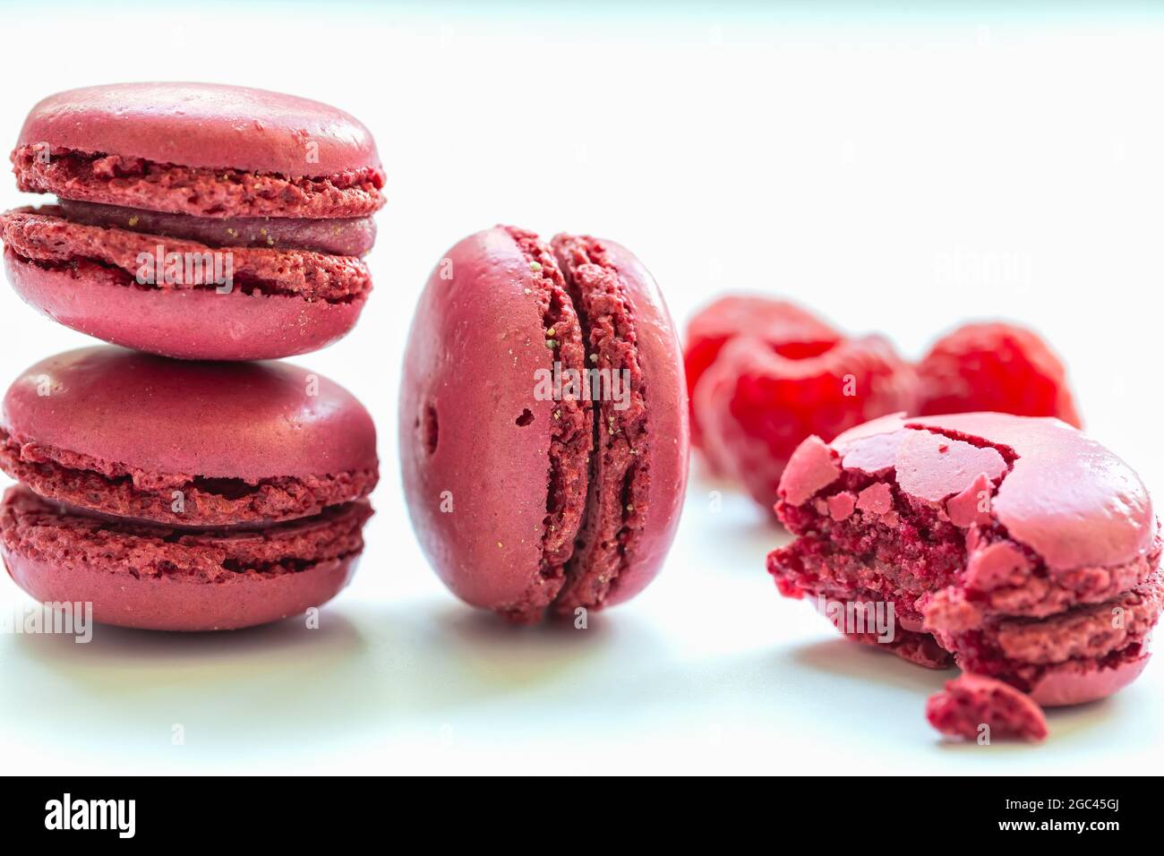 Raspberry flavored macaroons in white background Stock Photo - Alamy