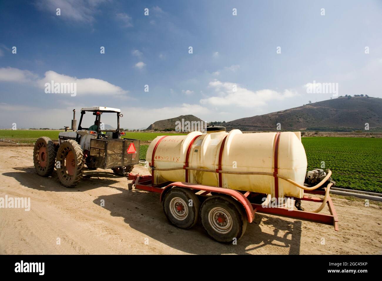 Tractor puling tank of liquid fertilizer Stock Photo - Alamy