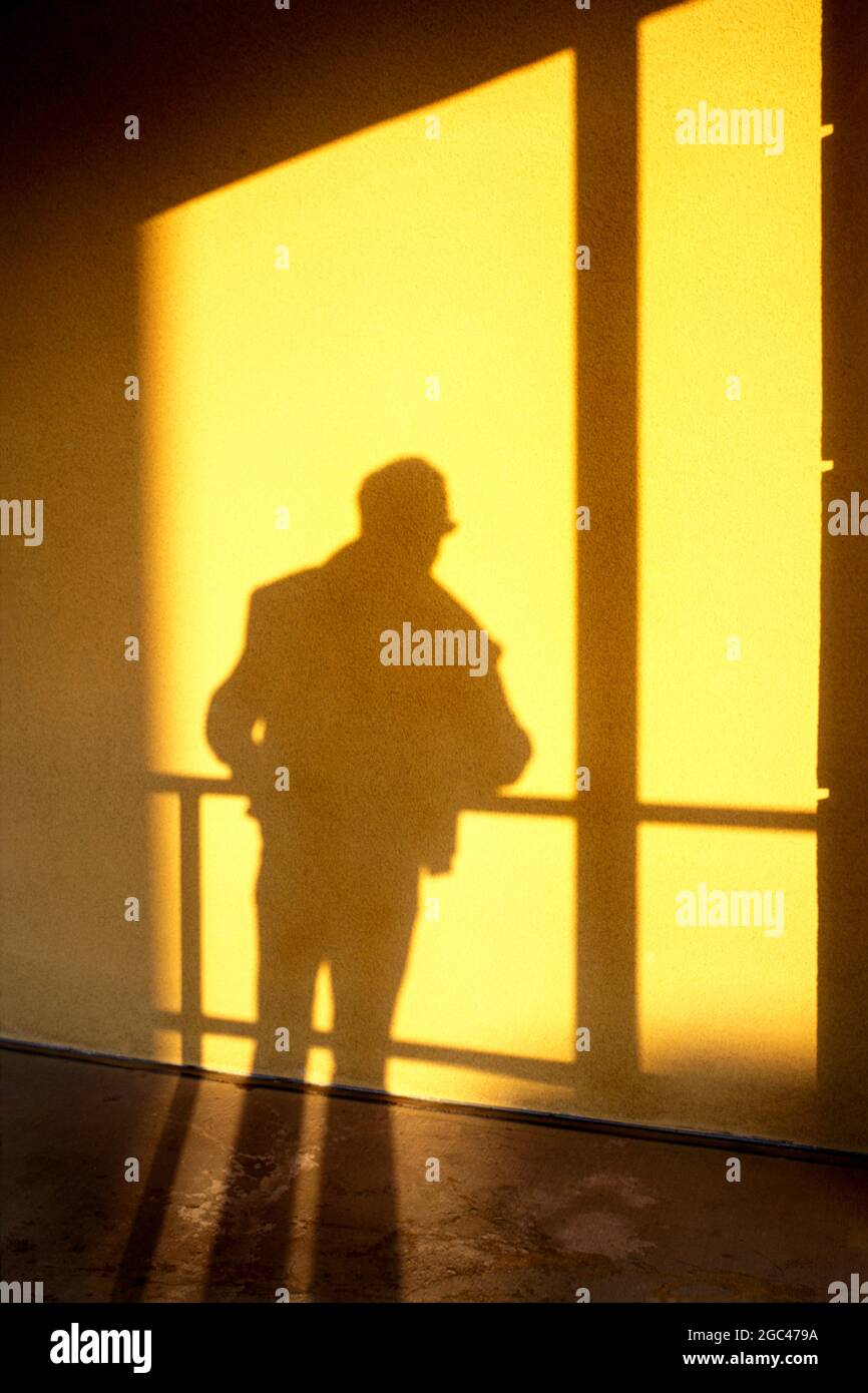 Man's shadow on building Stock Photo - Alamy