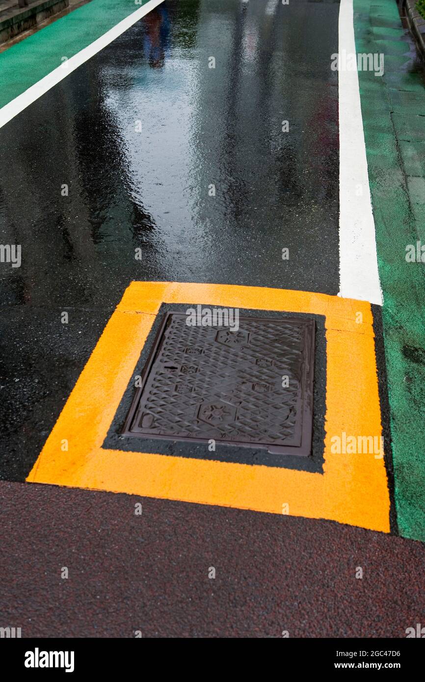 Bright yellow paint on a rainy street in Omotesando, Tokyo, Japan Stock ...